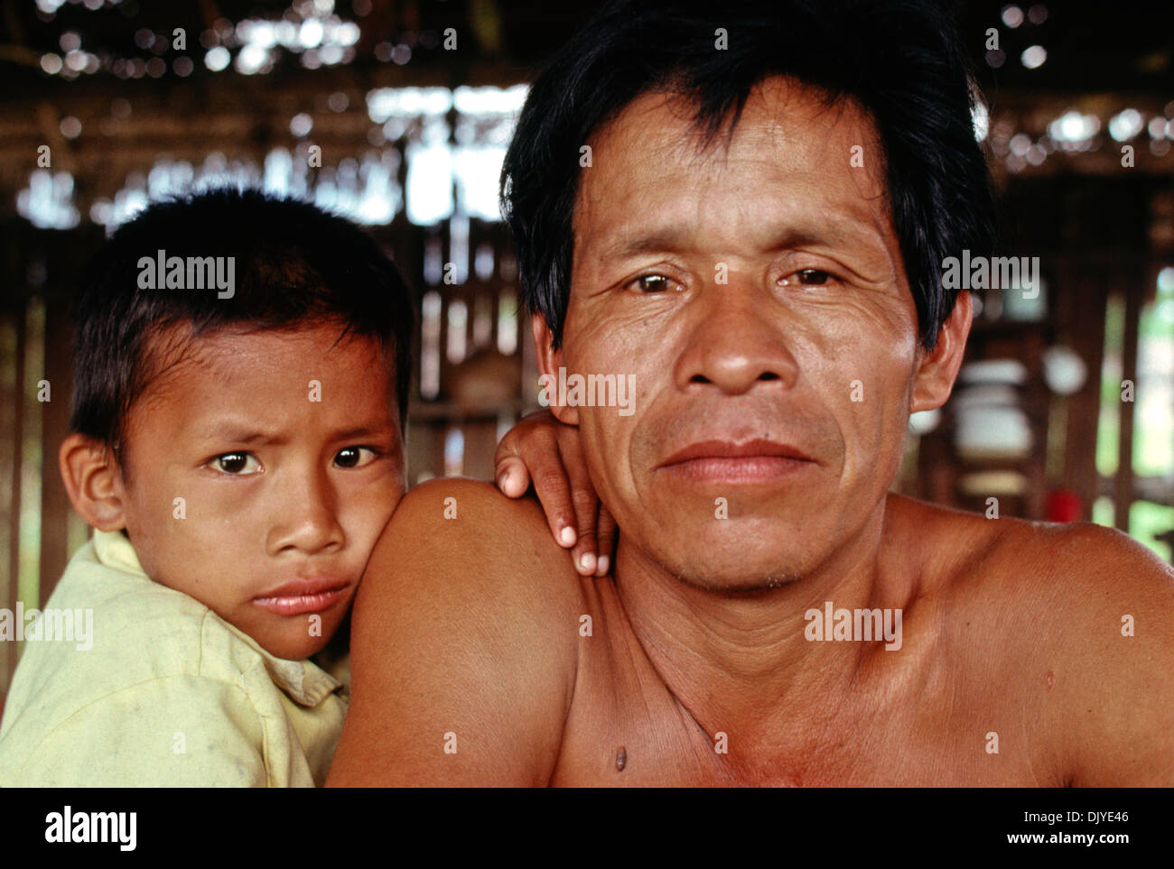 A father and his son in their hut in the Peruvian Amazon on the Rio ...