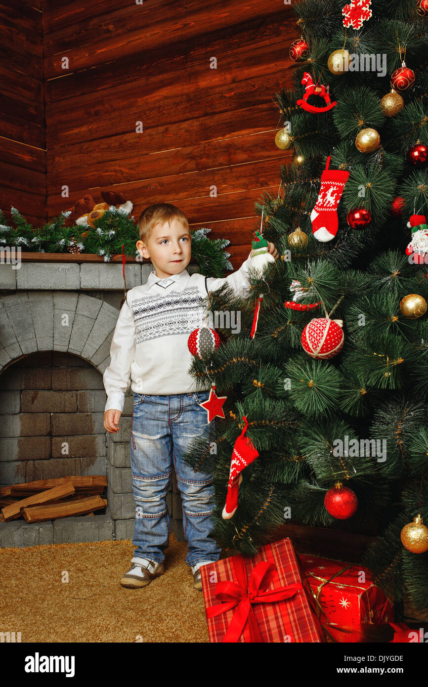 Boy shot on background with Christmas tree, gifts and fireplace Stock ...