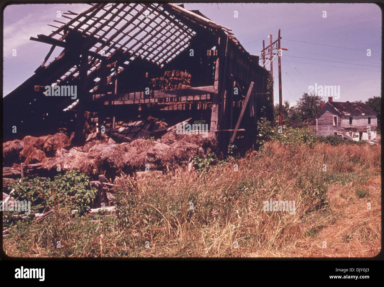 An abandoned barn in Ohio succumbs to decay, alongside an empty ...
