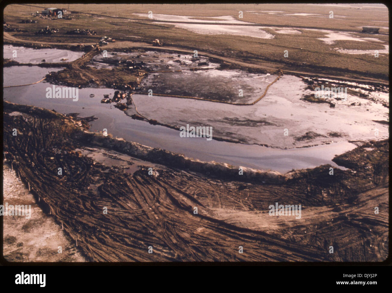 An aerial view of a five-acre pond during its cleanup, showing the ...