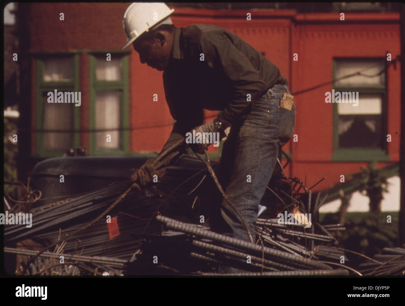 A Black construction worker is shown working in South Side Chicago. The ...
