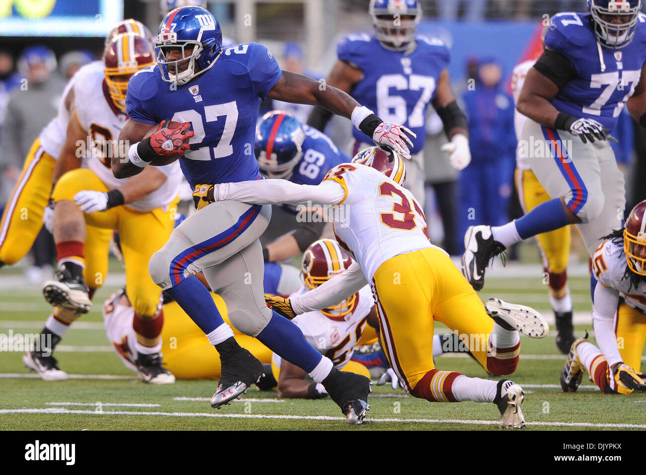 New York Giants running back Brandon Jacobs (27) runs through an arm ...