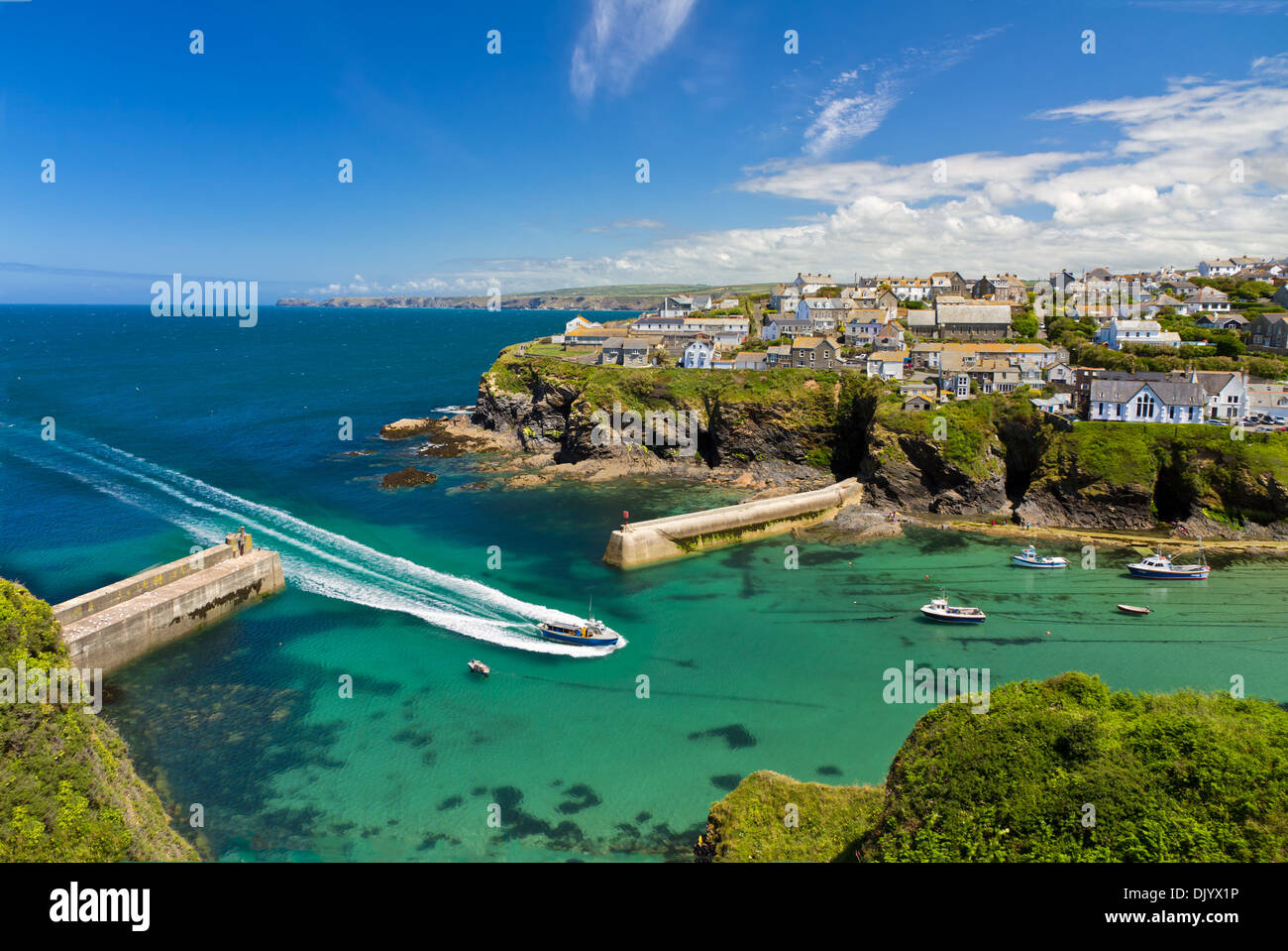 Cove and harbour of Port Isaac with arriving ship, Cornwall, England ...