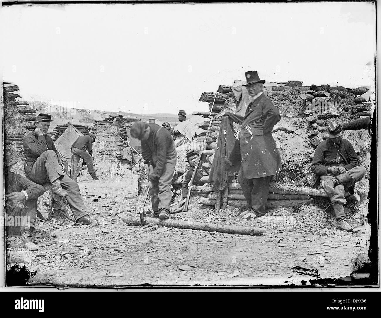 A winter camp scene showing soldiers or civilians in their quarters ...