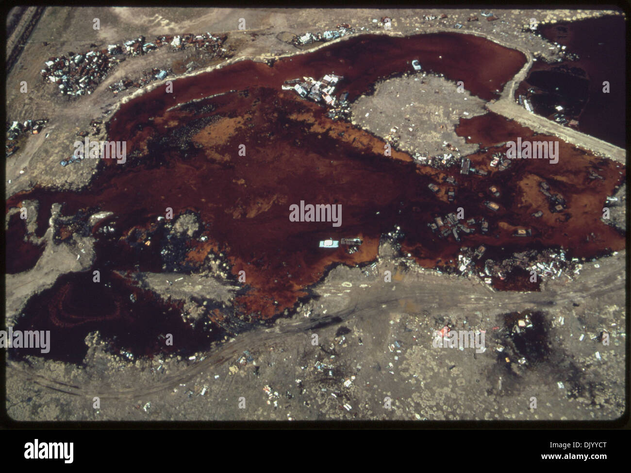 An aerial view of a five-acre pond containing acid water, oil, acid ...