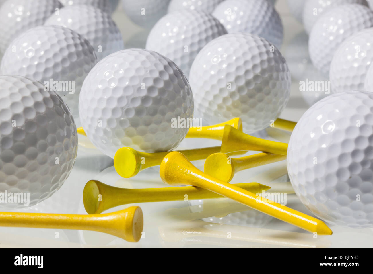 Different golf balls on a glass table Stock Photo - Alamy
