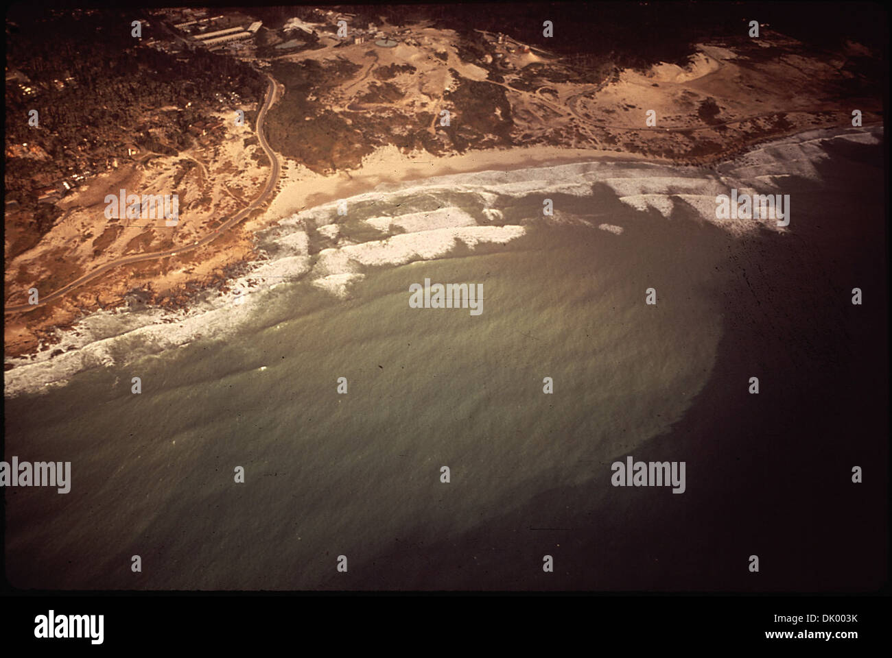The coastline depicted shows silt accumulation from a nearby river ...