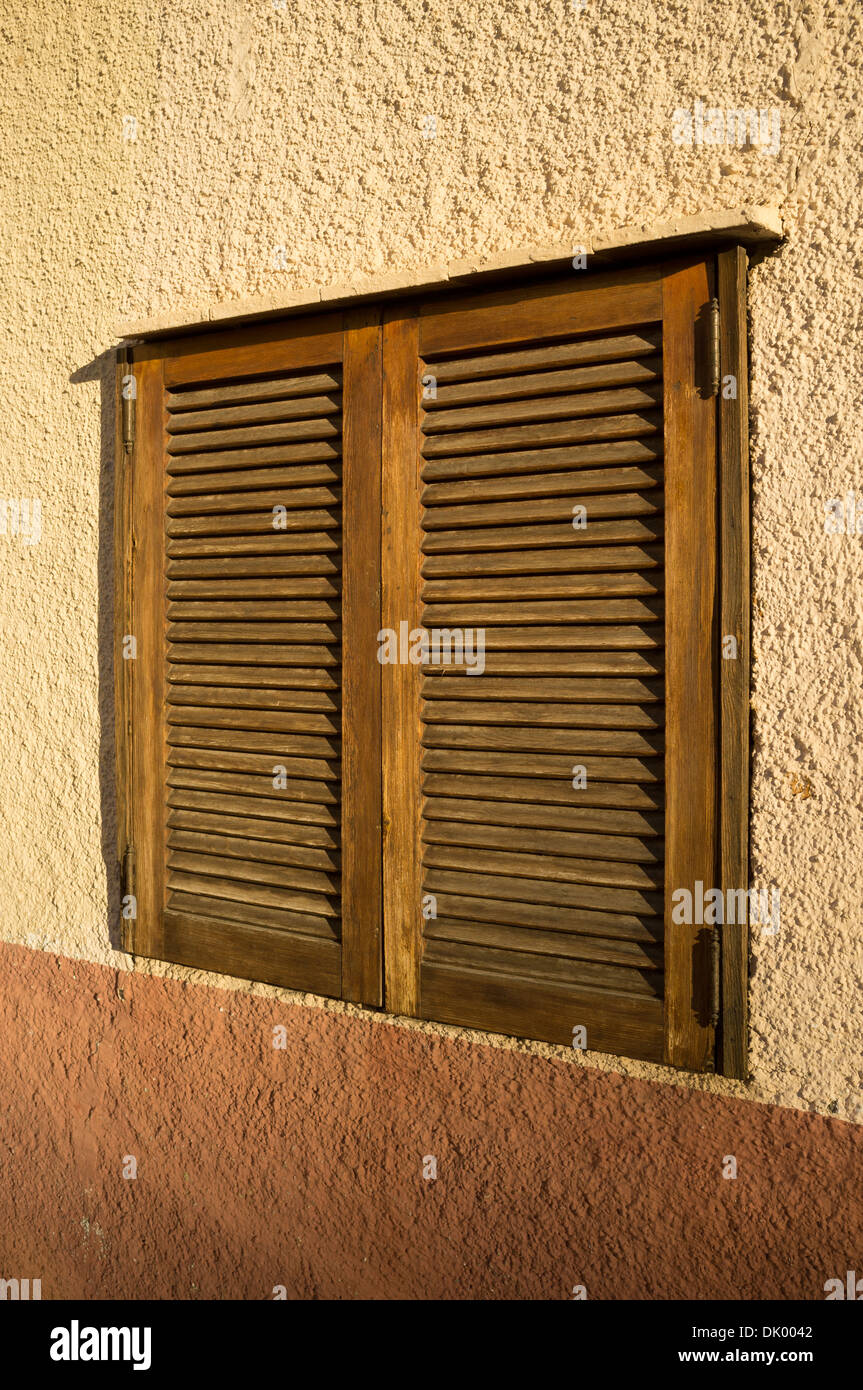 Mediterranean window with traditional closed wooden shutters Stock ...