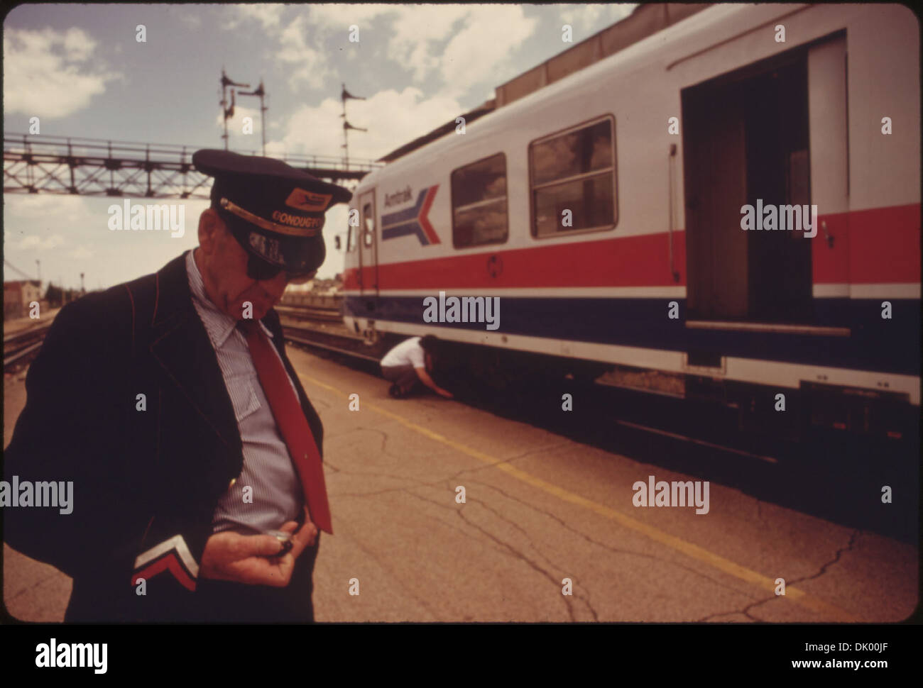 This image captures a conductor checking his watch at a Bloomington ...
