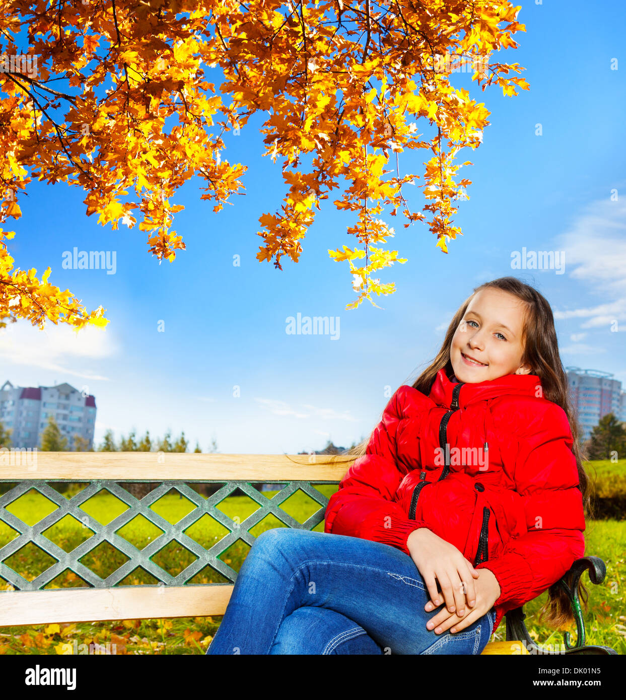 Autumn Portrait Of A 11 Years Old Girl Sitting On The Bench In The Park