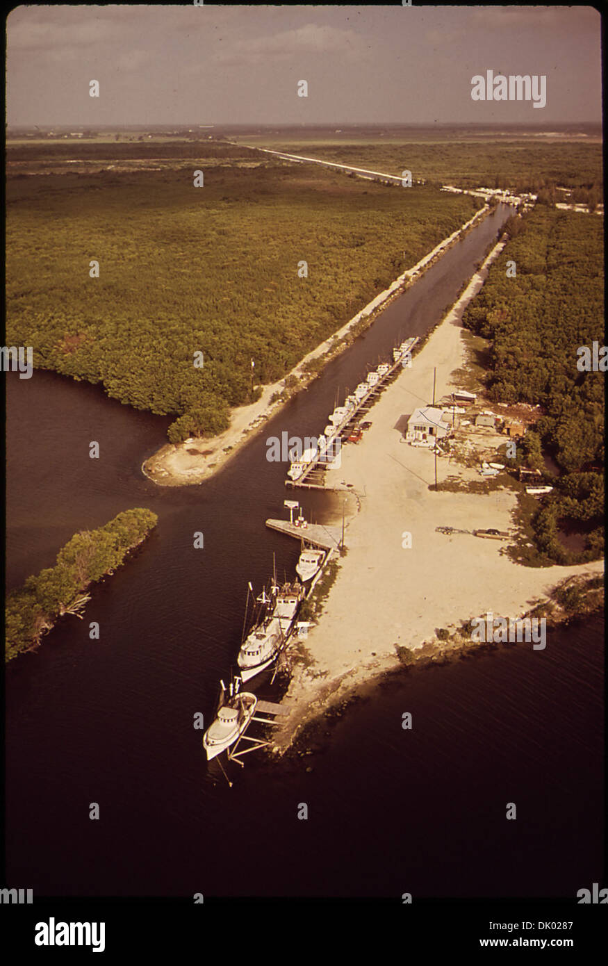 This photograph shows a drainage canal flowing into Biscayne Bay ...