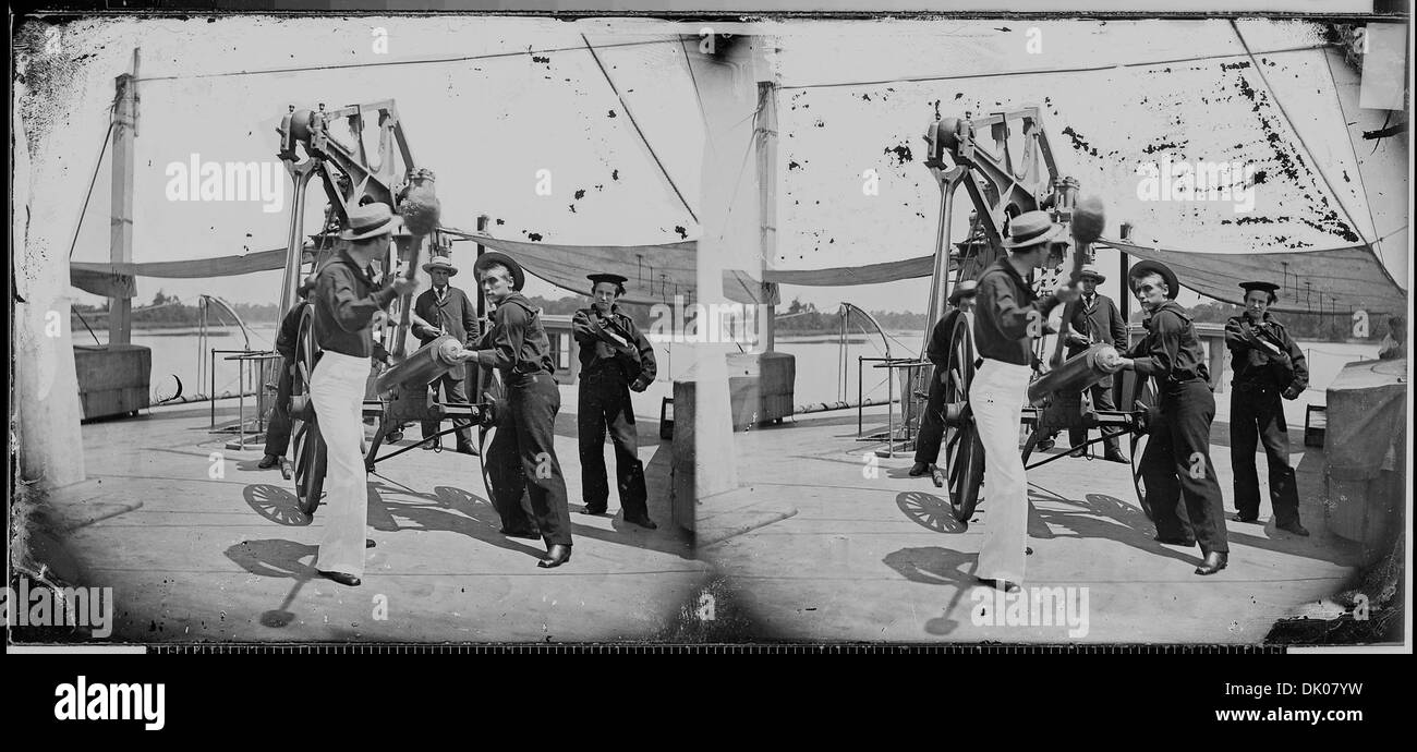A gun squad is stationed on the deck of a monitor, a type of warship ...