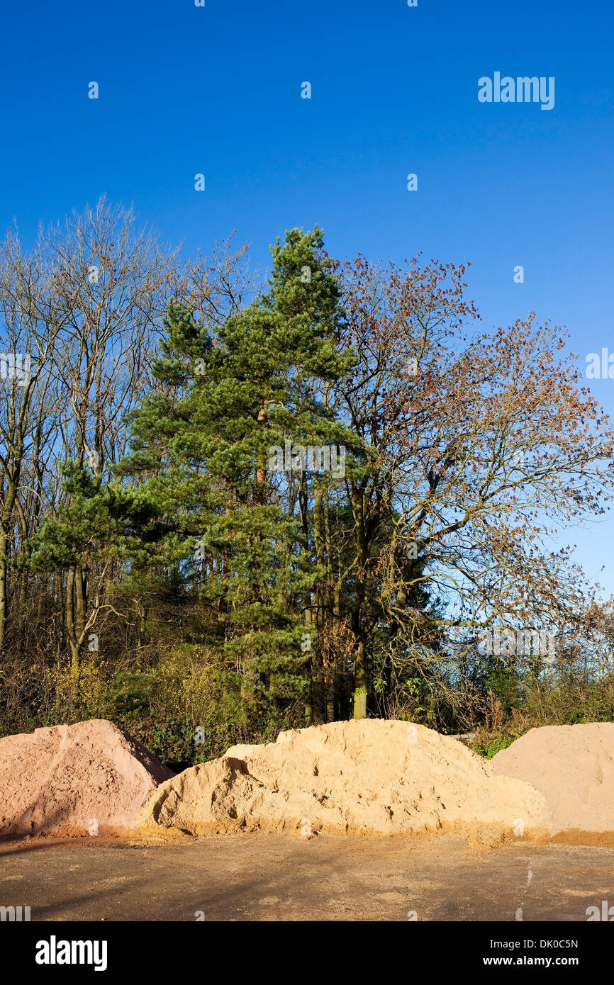 A stock pile of rock salt by a rural highway ready for winter with a ...