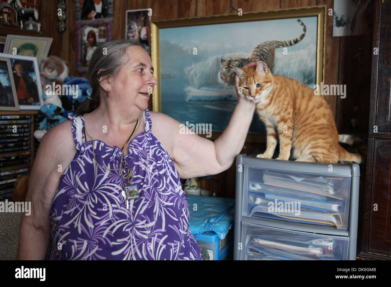 Christine Gregory, 62, with one of her 12 cats, inside her post-war ...
