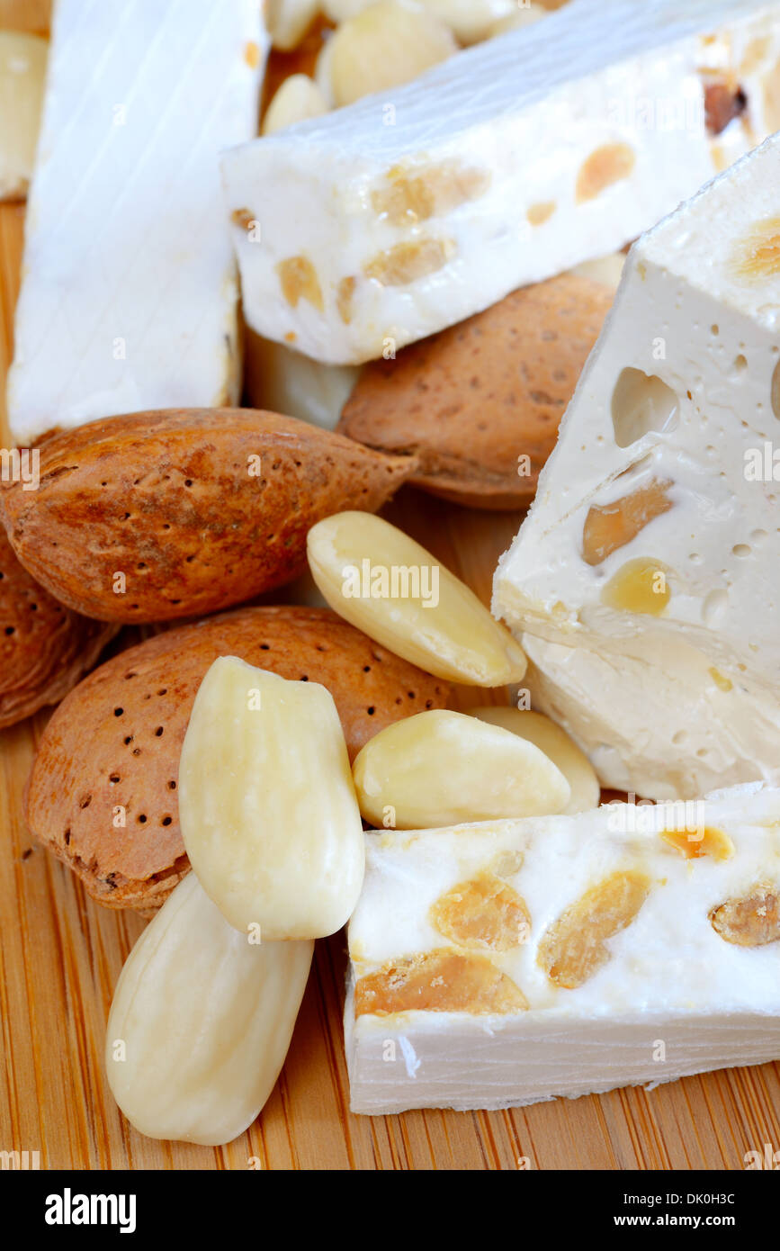 sweet white honey nougat with almonds on cutting board Stock Photo - Alamy
