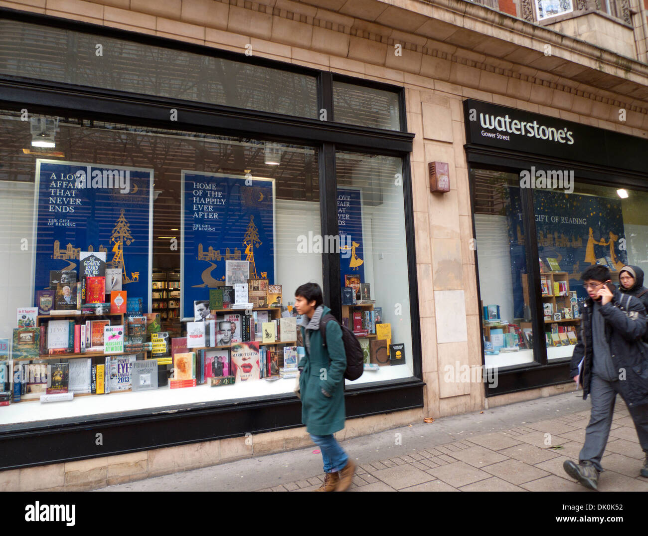 People passing Waterstones Book Store window display in Gower Street ...