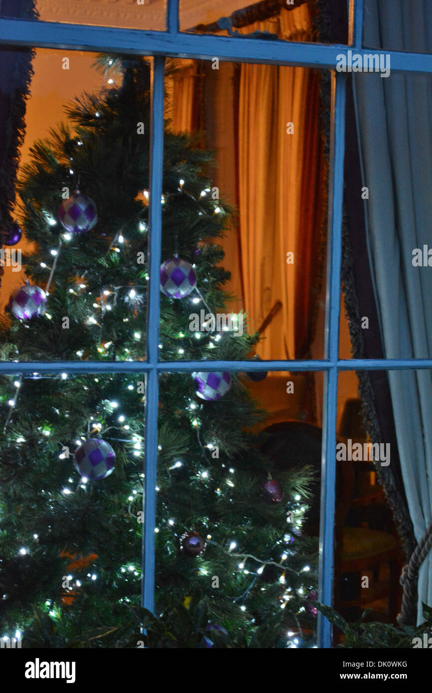 Beautiful Christmas tree in the window of a house Stock Photo - Alamy