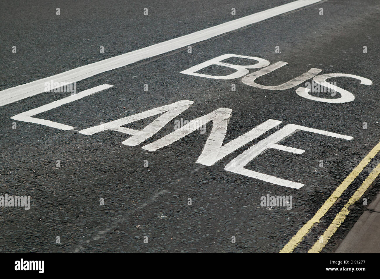 Bus Lane written on road in white paint next to double yellow lines ...