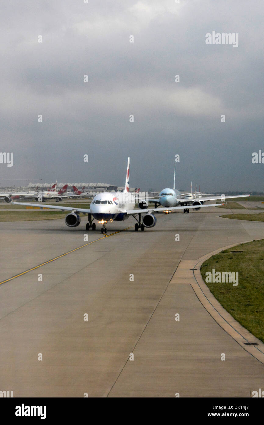 Line of aircraft waiting to take off from London heathrow on a busy ...