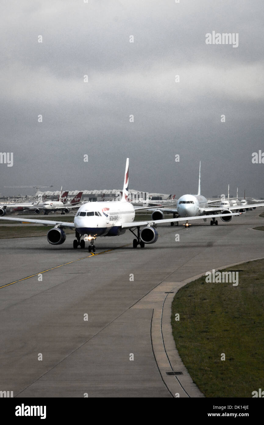 Line of aircraft waiting to take off from London heathrow on a busy ...