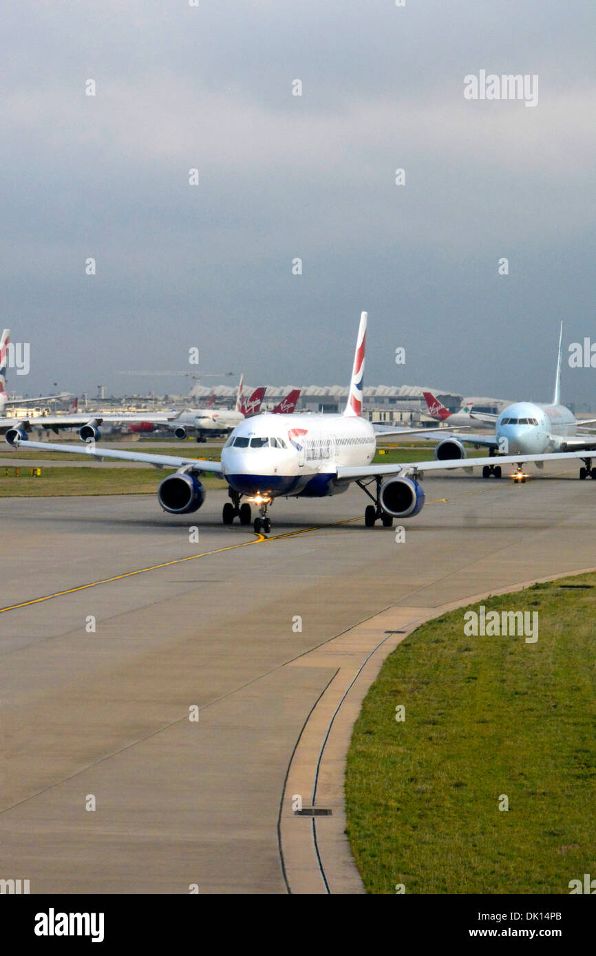 Line of aircraft waiting to take off from London heathrow on a busy ...