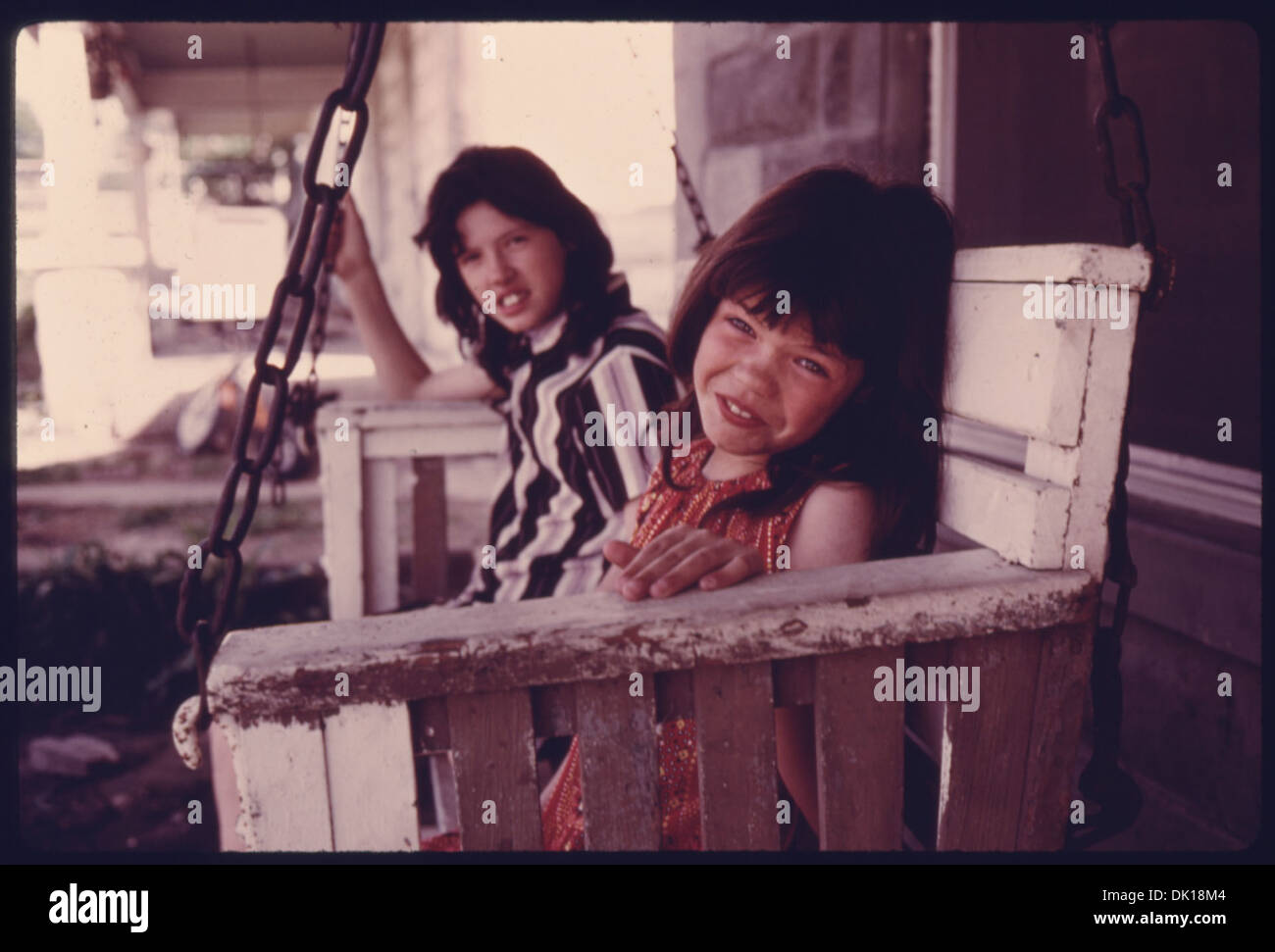 Sandy Watkins and her sister Diane relax on the porch and swing of ...