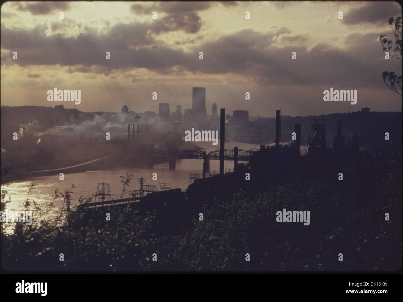 Industrial smoke from factories creates a visible haze over Pittsburgh ...