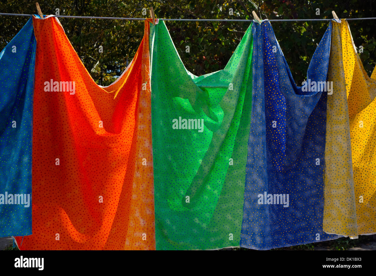 bright colored fabric on clothing line Stock Photo - Alamy