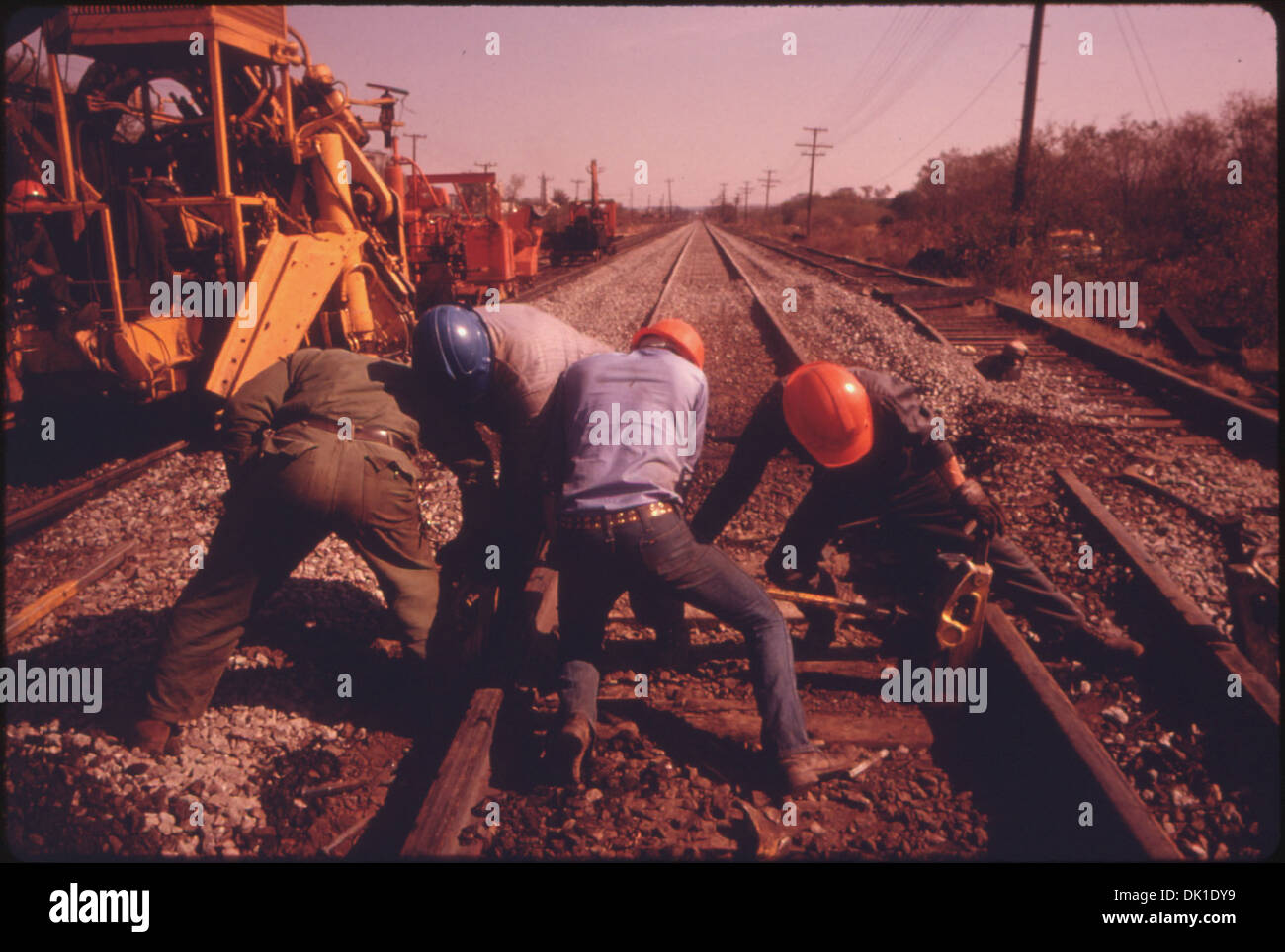 A Southern Railway work crew is shown jack up a rail, replacing old ...
