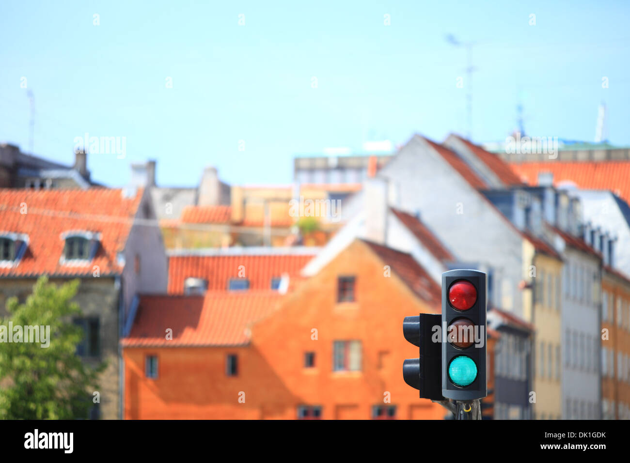 Green color on the traffic lights against city background Stock Photo ...
