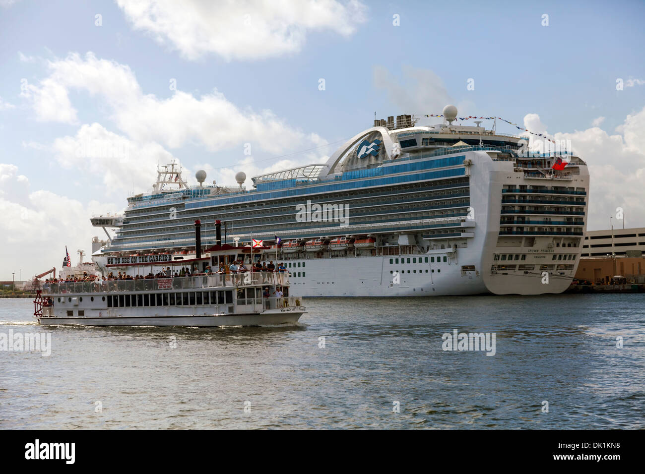 The Carrie-B tour boat passes the Crown Princess cruise ship operated ...