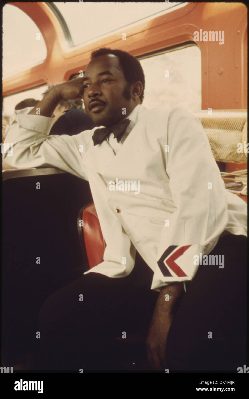 This photograph shows a waiter serving passengers in the lounge car of ...