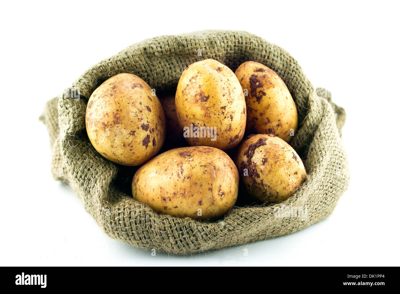 potatoes in burlap sack isolated on white background Stock Photo - Alamy