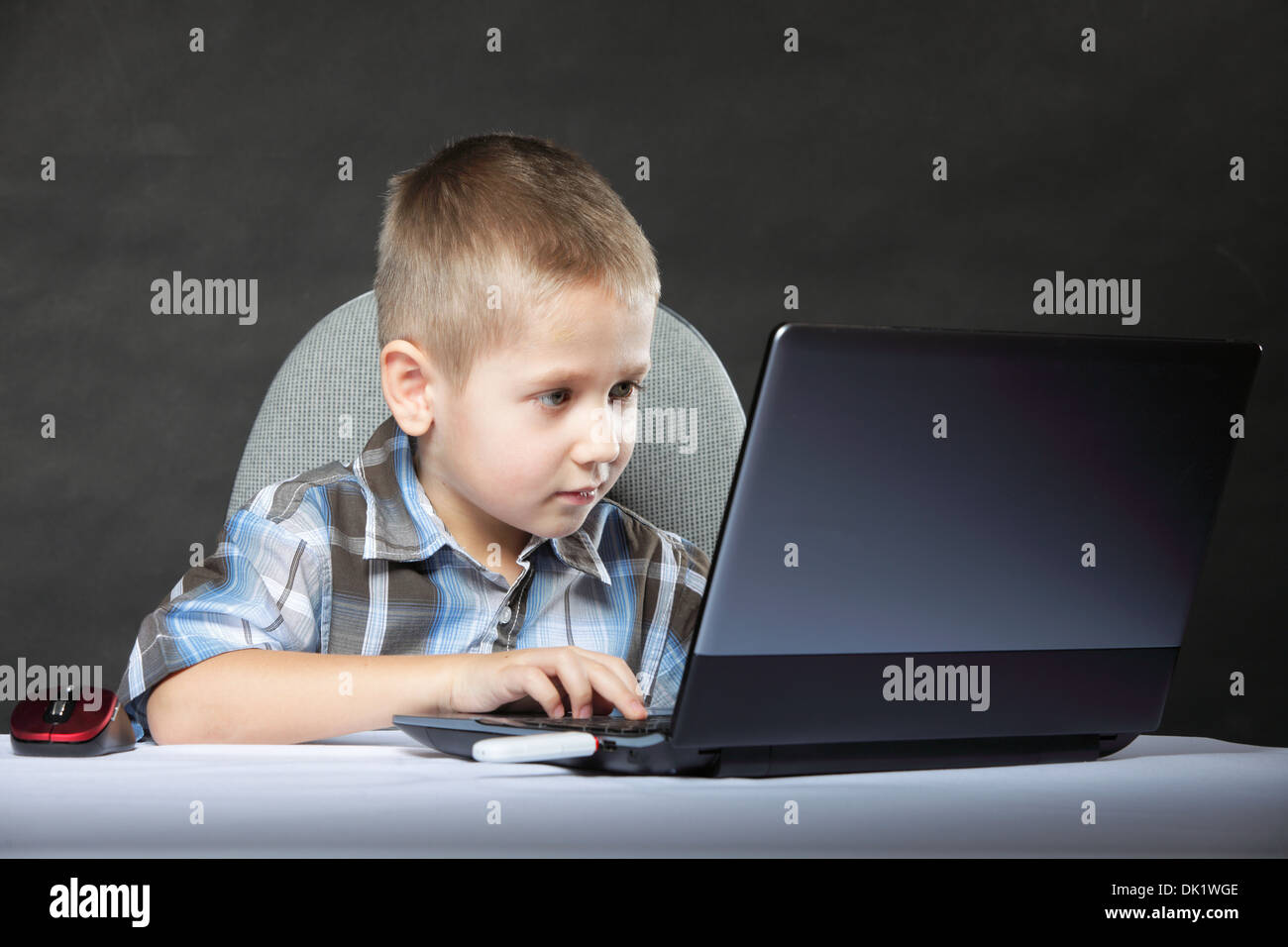 Computer addiction child boy with laptop notebook black background ...