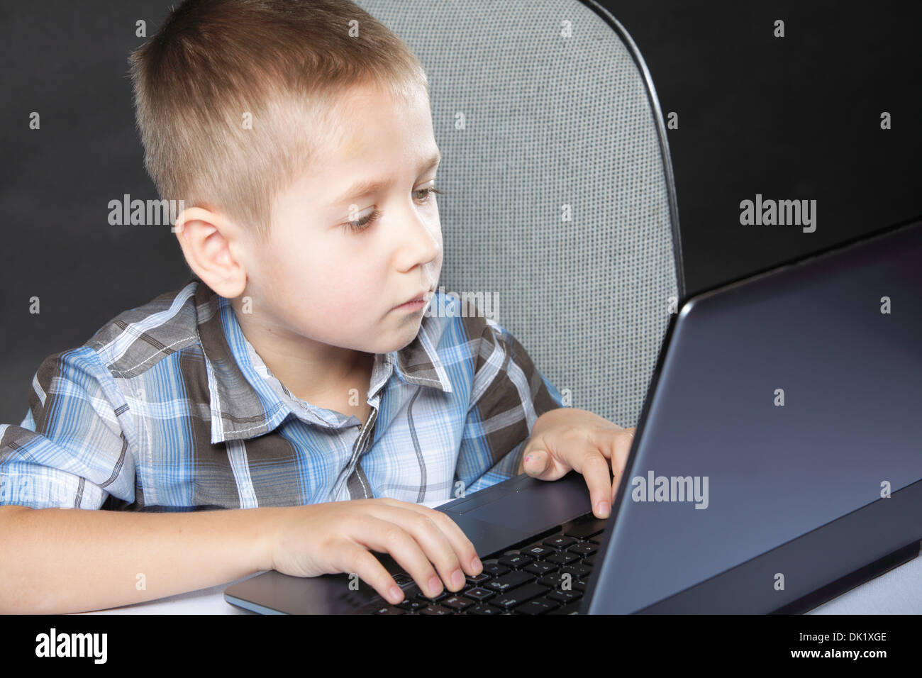 Computer addiction child boy with laptop notebook black background ...