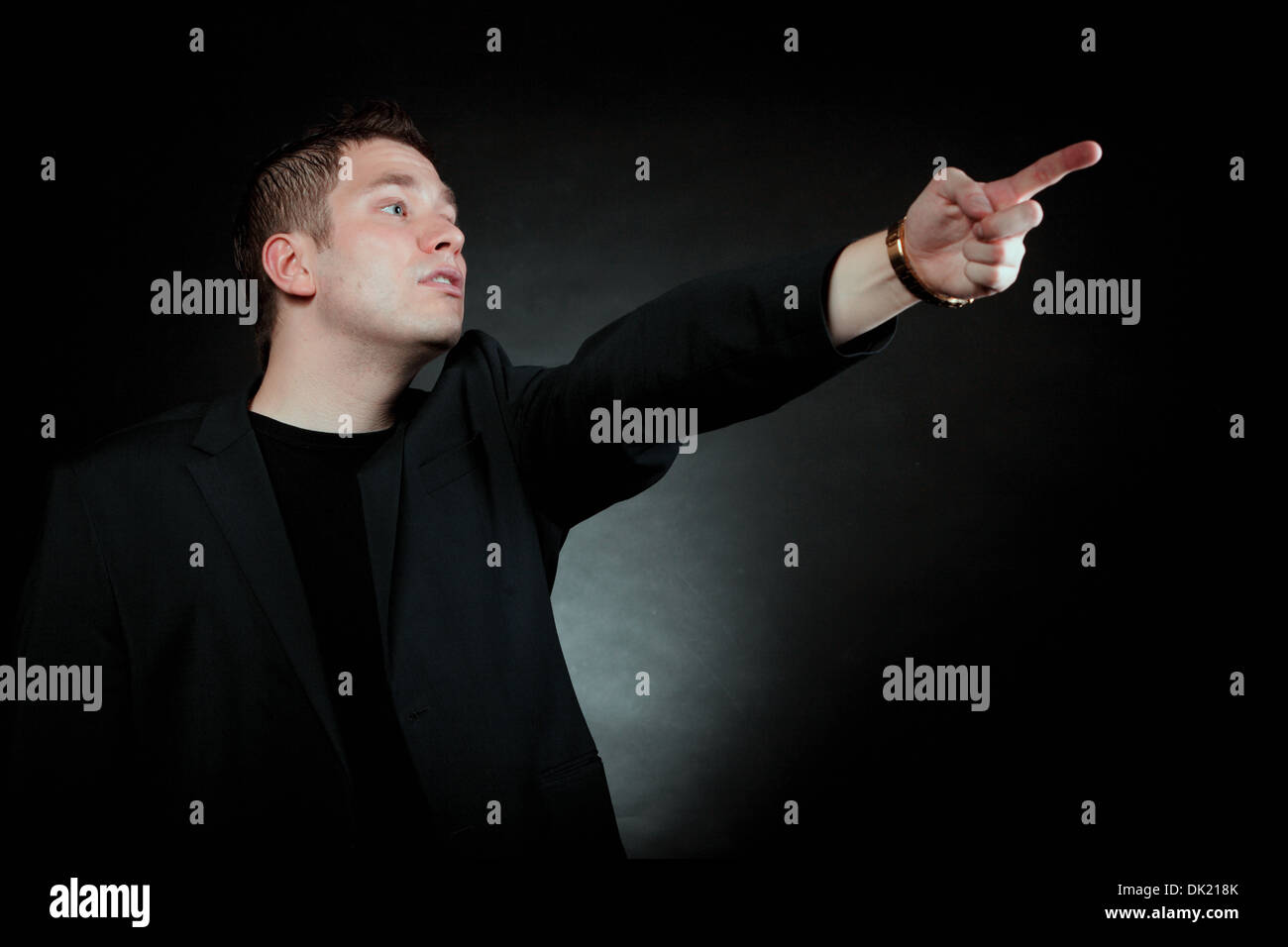 Surprised man pointing at something interesting showing your product ...