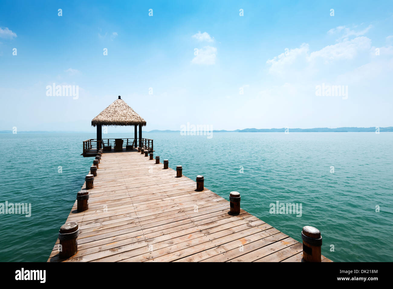 Wooden jetty over the beautiful Maldivian sea with blue sky Stock Photo ...