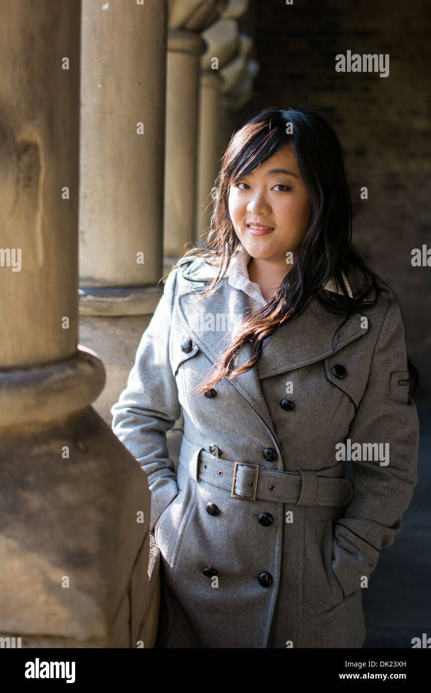 Young Asian woman standing near pillar structure Stock Photo - Alamy