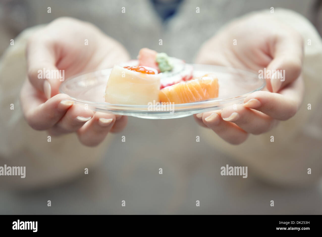 Human hands holding plate with sushi Stock Photo - Alamy