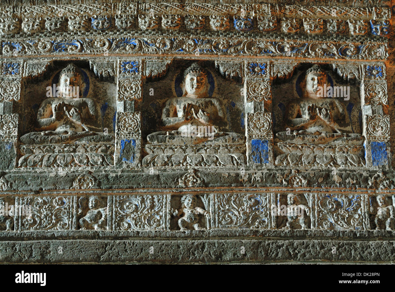 Cave 26: Frieze above pillars. Three Buddha figures seated in Padmasana ...