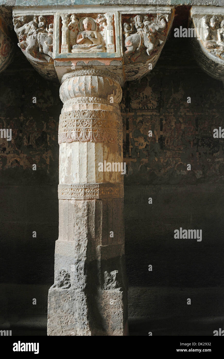 Cave 19: Full Pillar with details. Shows seated Buddha figure in ...