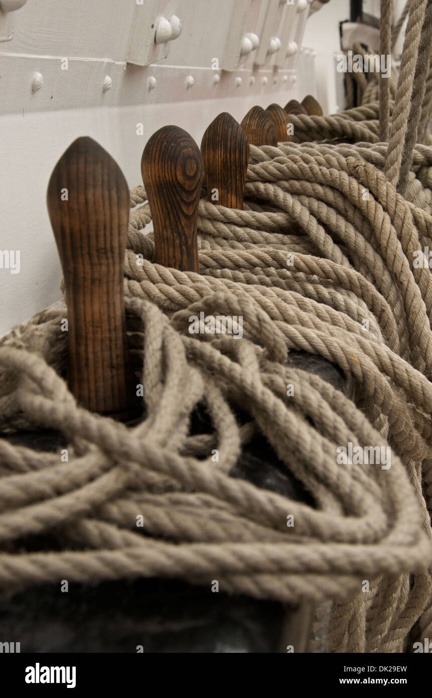 Lengths of ships rope coiled around wooden pegs on board HMS Gannet at ...