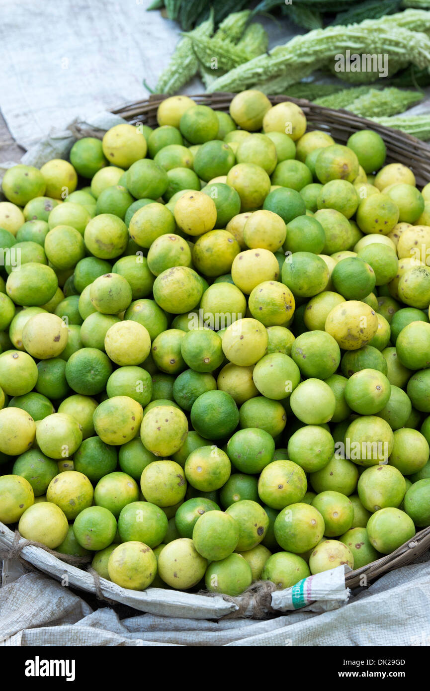 Indian lemons in a basket at an Indian street market. Andhra Pradesh ...