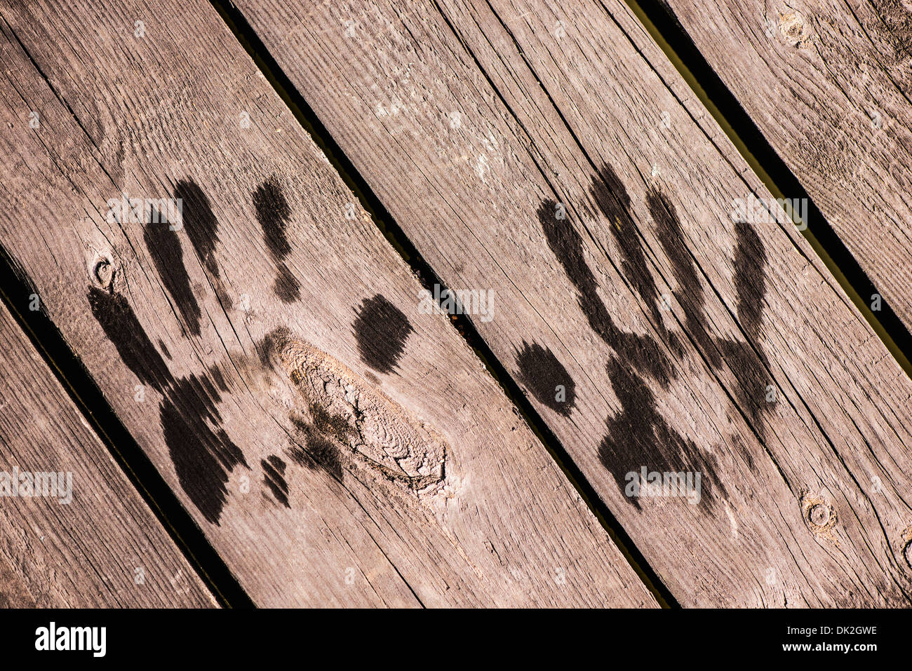 Lifestyle moment of summer childhood. Wet handprints on wooden surface ...