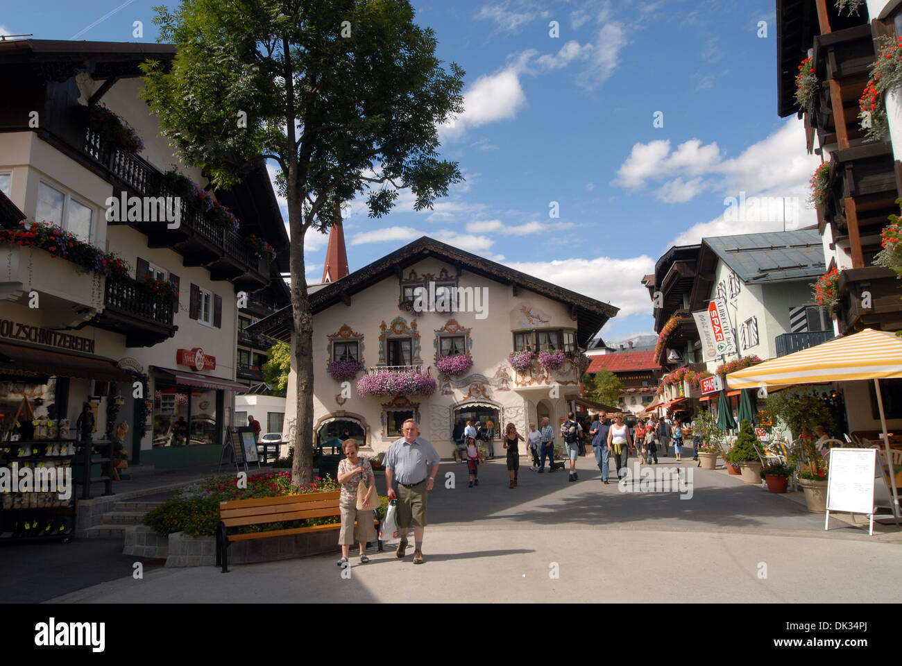 Seefeld, Austria, with people walking down the main street on a summers ...