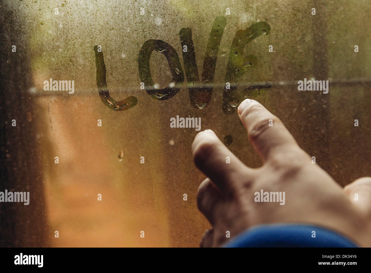 Little kid writing the word love on a condensed window Stock Photo - Alamy