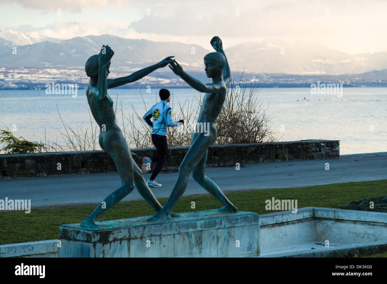 Statue of a boy and a girl with a runner in the background Stock Photo ...