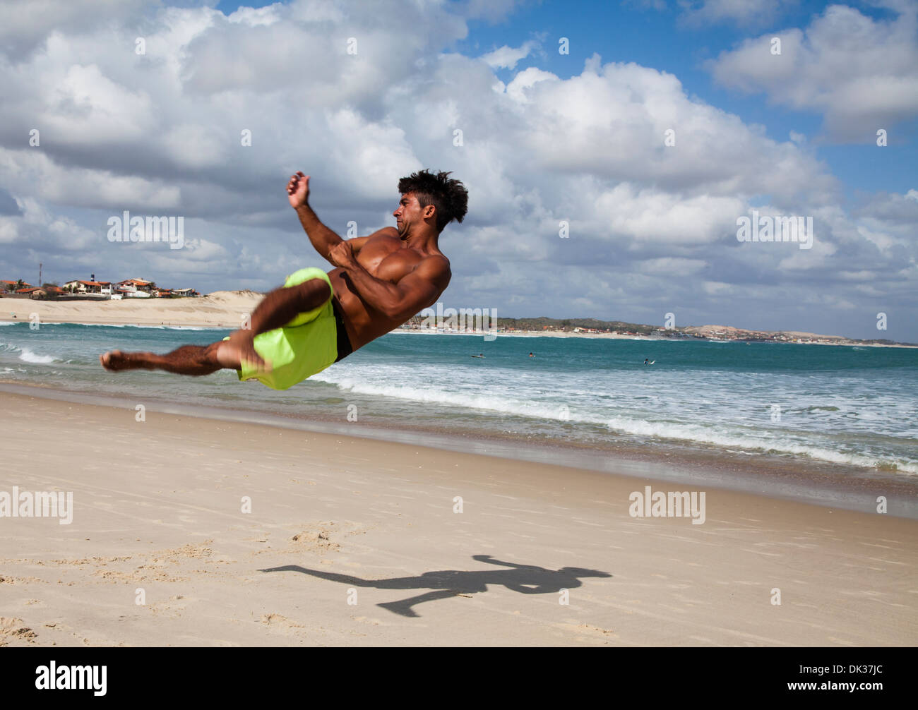 Man doing acrobatics on the beach in Iguape, Fortaleza district, Brazil ...