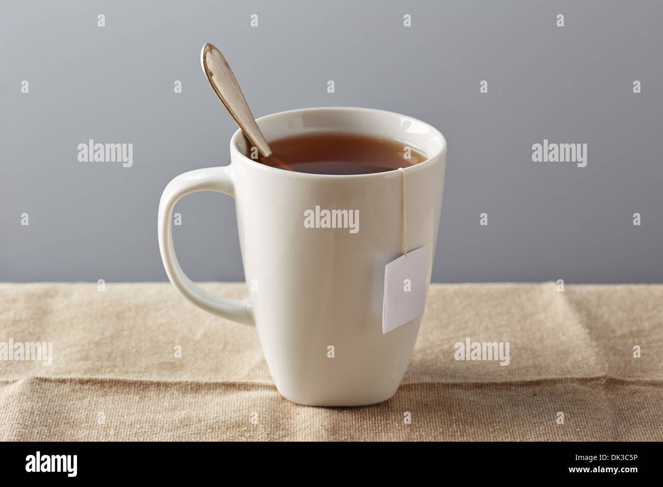 White cup of tea on beige fabric Stock Photo - Alamy