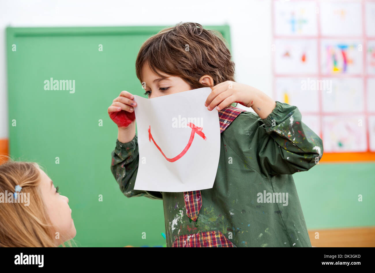 Boy Holding Paper With Smile Drawn On It Stock Photo - Alamy